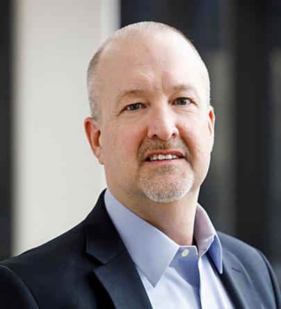 Headshot of Invista CEO Francis Murphy wearing a dark open suit jacket ...